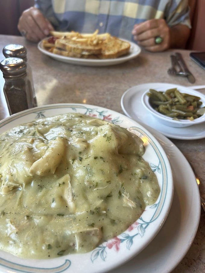 Chicken and dumplings swimming in gravy so rich it could buy a yacht. This isn't just comfort food—it's therapy.