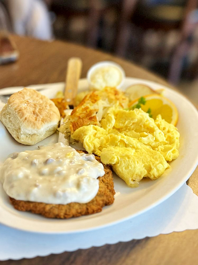 Country-fried steak with gravy alongside fluffy scrambled eggs—comfort food that gives you a warm hug from the inside out.