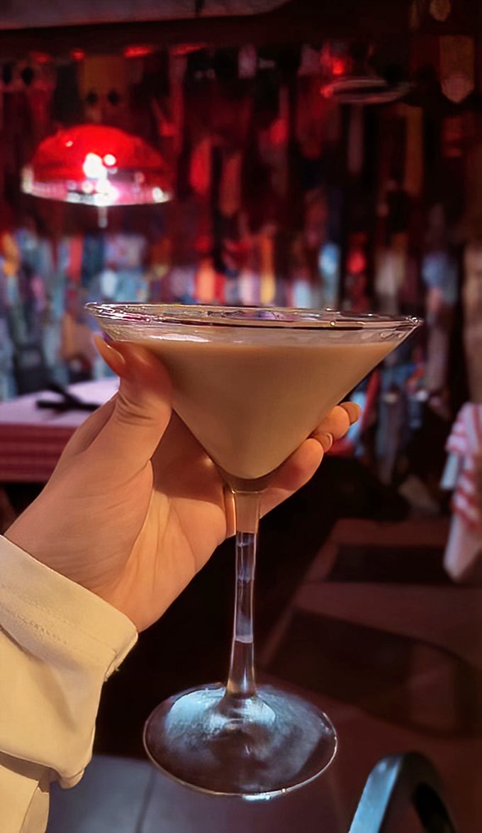 A perfectly mixed martini catching the warm glow of the bar lights—liquid velvet that makes waiting for your steak a pleasure, not a chore.