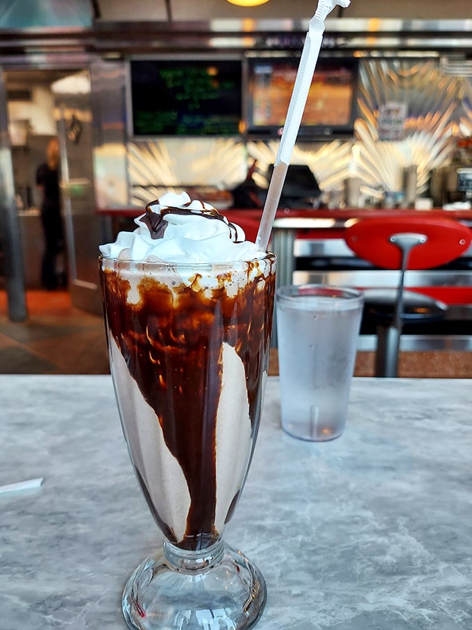 This chocolate milkshake isn't just a drink, it's a commitment—with whipped cream architecture that belongs in a museum of delicious decisions.
