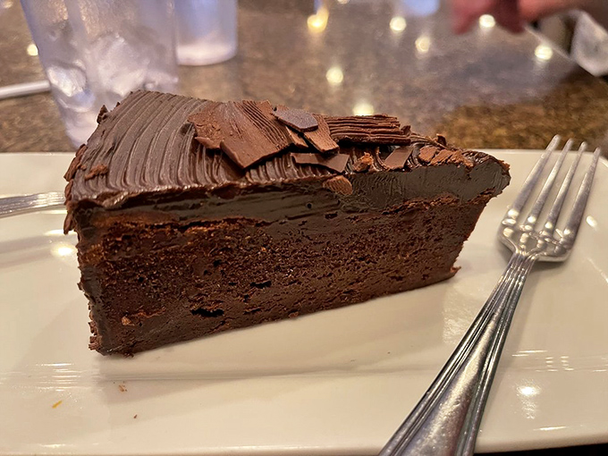 A slice of chocolate cake so rich and decadent it should come with its own tax bracket and financial advisor.