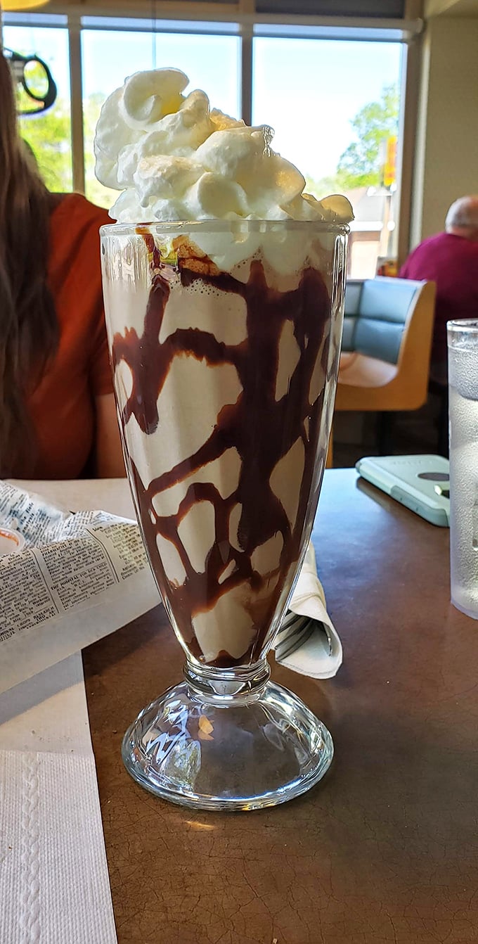 This chocolate milkshake isn't just a drink, it's architecture – layers of chocolate and cream building toward a whipped cream summit that demands respect.