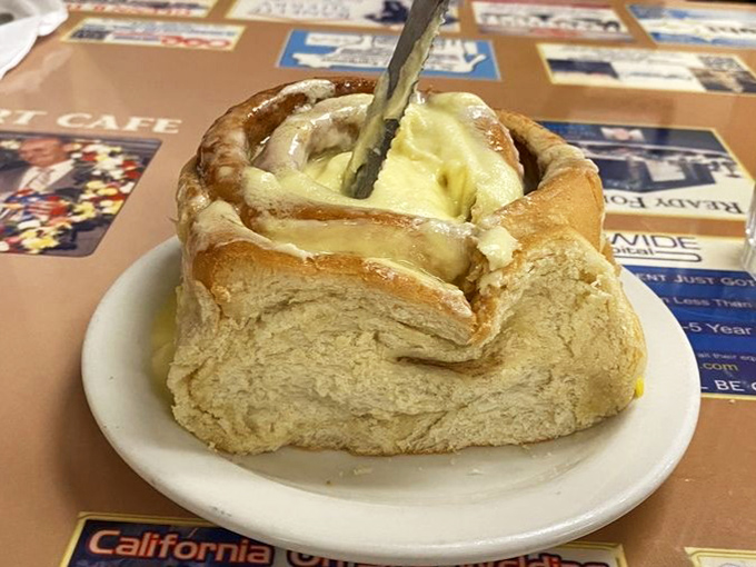 This isn't just a cinnamon roll—it's a butter-soaked spiral of happiness that's worth every calorie and every minute on the treadmill afterward.