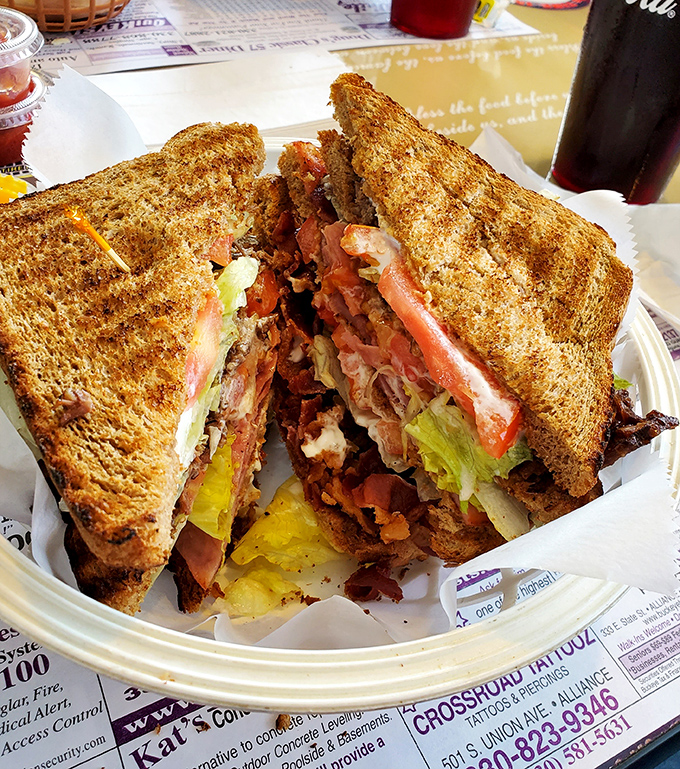 The club sandwich—that multi-story mansion of flavor where bacon, mayo, and toasted bread create the kind of architecture that would make Frank Lloyd Wright hungry.