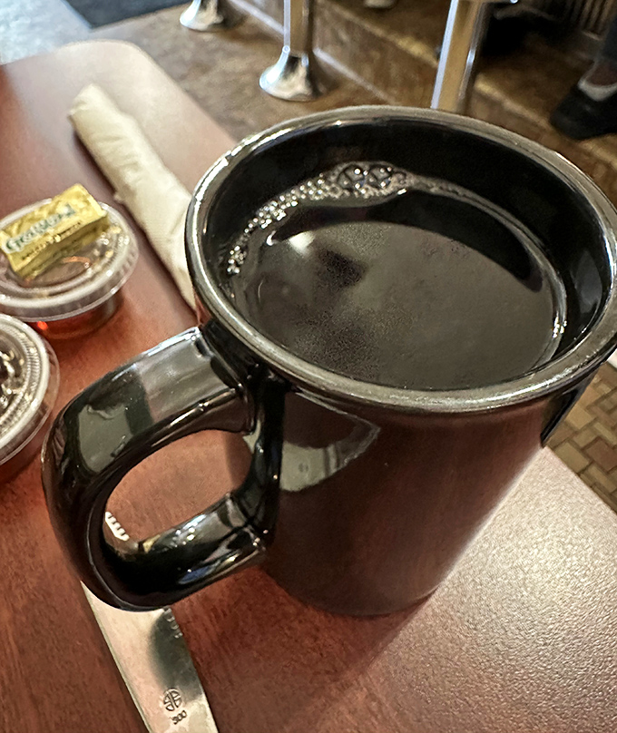 The cornerstone of any proper morning—black coffee in a sturdy mug with no pretension. Like a loyal friend, it shows up exactly when you need it.