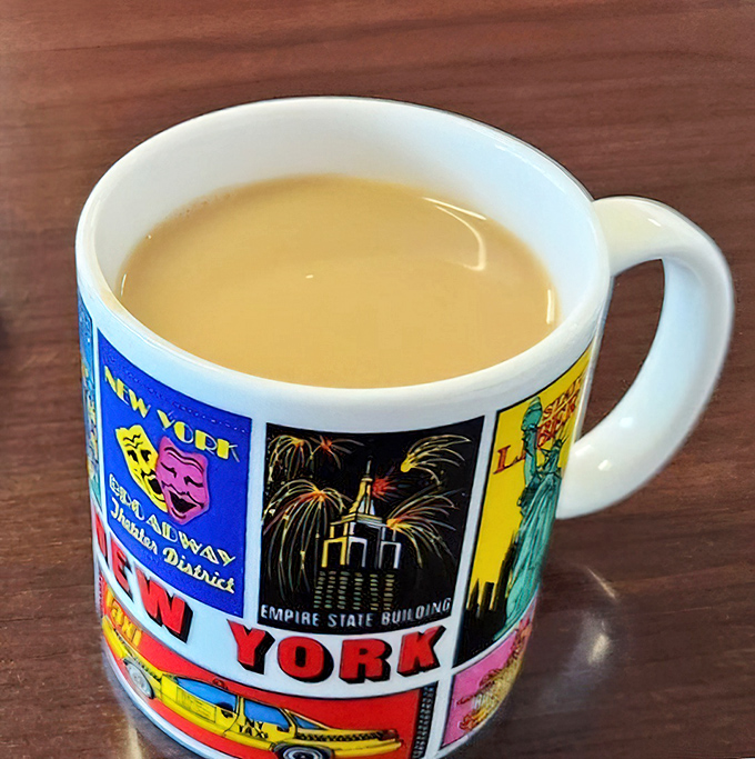 Coffee served in a souvenir mug, because regular cups can't contain the diner magic. This isn't just caffeine—it's liquid motivation.