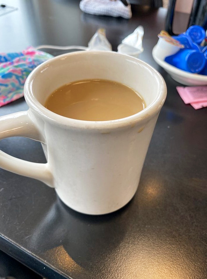 That classic white diner mug isn't just holding coffee—it's cradling liquid motivation in ceramic form. The unofficial mascot of morning people everywhere.