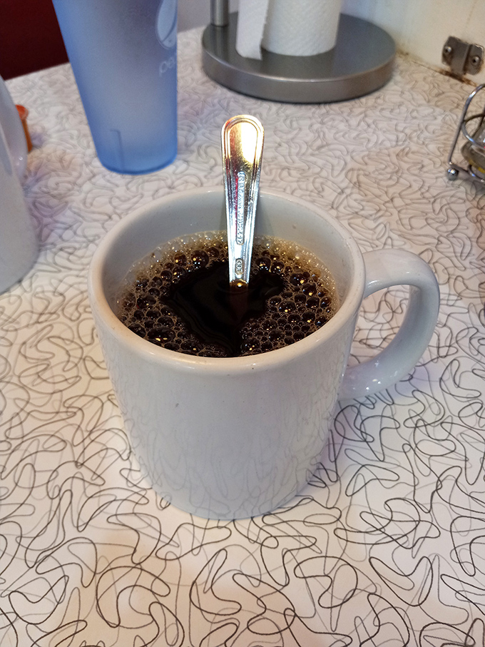 The humble coffee mug—steaming, dark, and promising to transform you from zombie to human with each perfectly brewed sip.