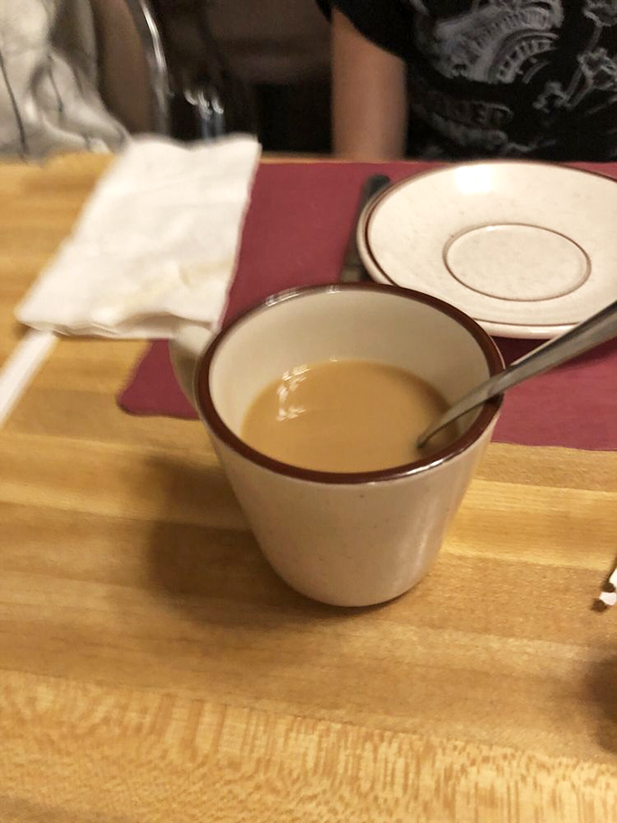 Coffee in a classic diner mug – the unsung hero of breakfast, promising warmth, caffeine, and unlimited refills of liquid motivation.