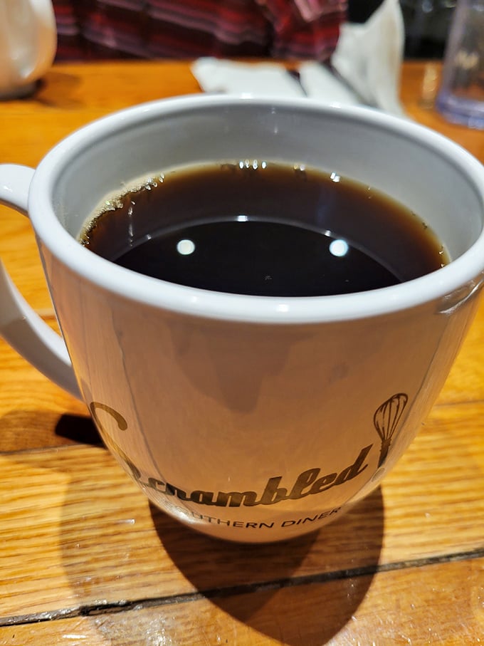 A proper cup of coffee in a branded mug—because what's the point of exceptional breakfast food without its faithful companion?