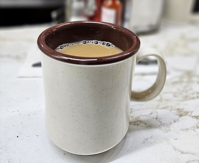 Coffee served in mugs that mean business. No fancy latte art here—just honest, hot coffee that's kept Detroit running for decades.