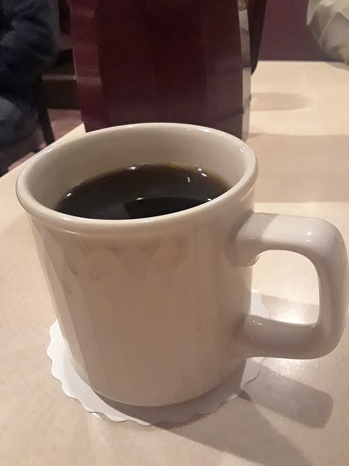 The humble diner coffee mug—holding what might be the most honest relationship you'll have all day. No foam art, just reliable warmth.
