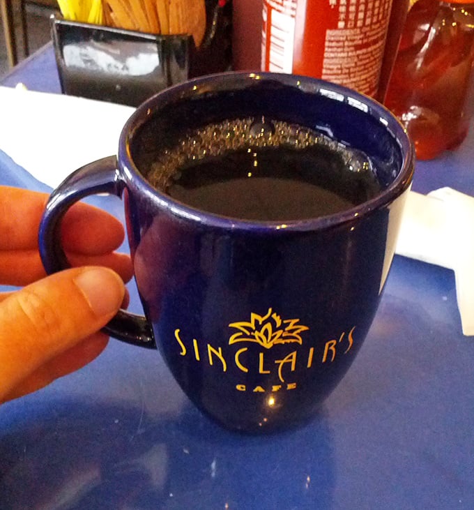 The navy blue coffee mug isn't just a vessel—it's a promise that what's inside will transform you from morning zombie to functioning human being.