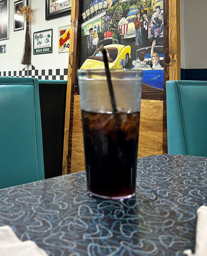 That classic soda sitting pretty against teal booth seating—some relationships are timeless, like diners and ice-cold fountain drinks. 