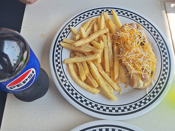 The classic combo – a cheese-topped dog, perfectly golden fries, and an ice-cold Pepsi. Some traditions don't need reinvention, just appreciation.