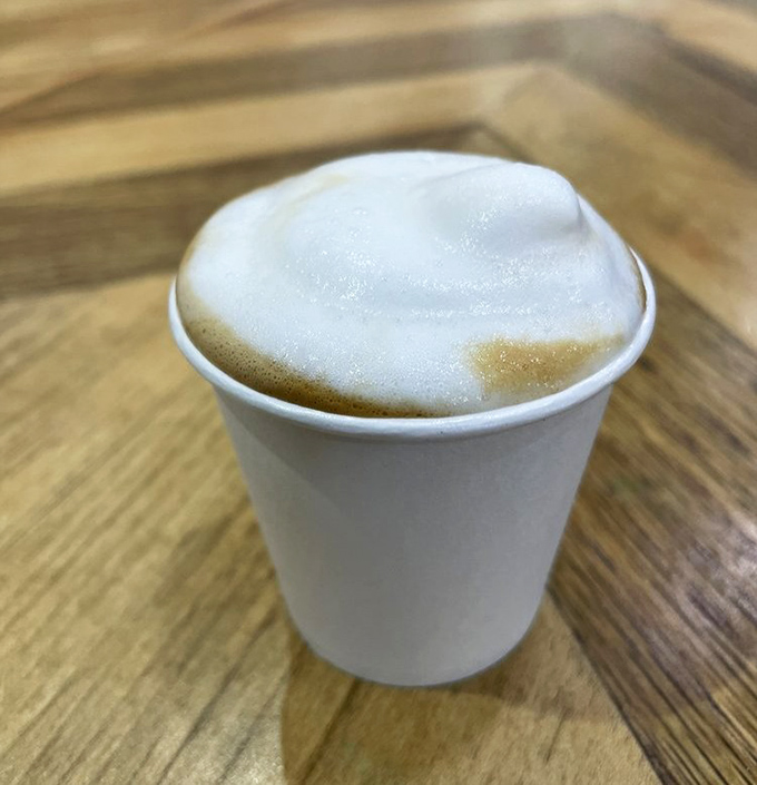 The cortadito's perfect foam cap sits like a cloud atop espresso heaven—proof that perfection sometimes comes in small packages.