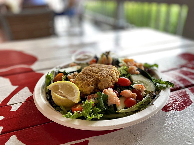 This isn't just a salad – it's a seafood celebration where fresh greens provide the perfect stage for that golden crab cake to shine.