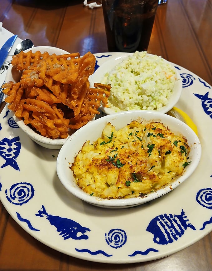 Crab imperial baked to bubbly perfection alongside sweet potato fries and crisp coleslaw creates dining harmony.