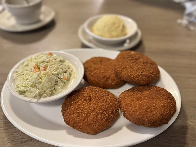 These crab cakes don't hide behind fancy garnishes—they're proudly showing off their golden-brown crust and promising sweet, lump crab meat inside.