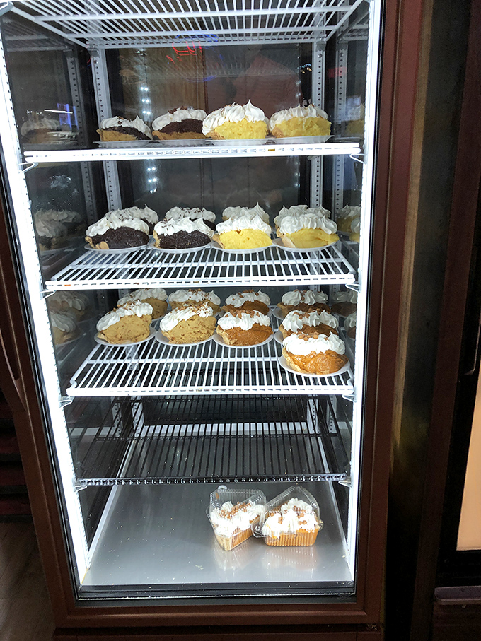 The pie case—a glass-fronted temple of temptation where decisions become impossible and "I'll just have a bite" becomes a laughable concept.