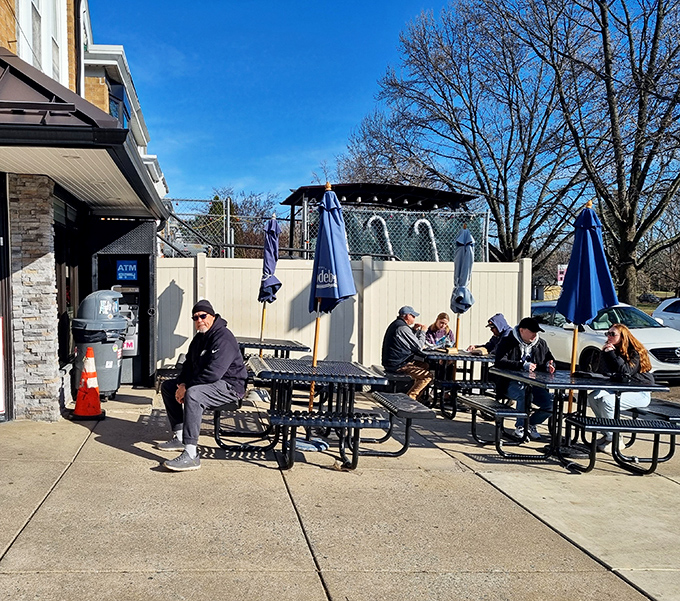The outdoor picnic tables—where strangers become friends united by the universal language of exceptional sandwiches.