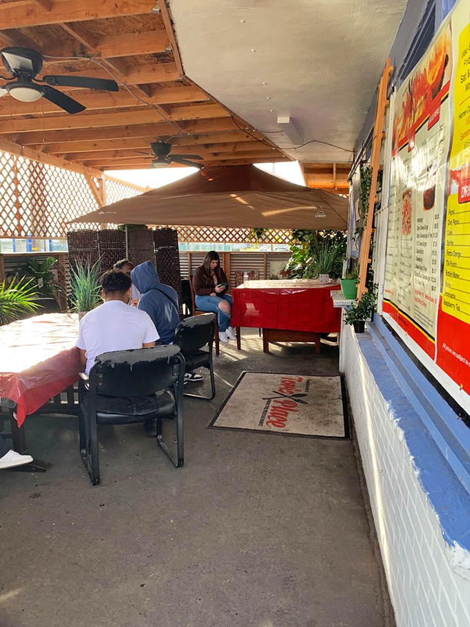Diners enjoying the covered patio experience. When the food is this good, even waiting becomes part of the adventure.