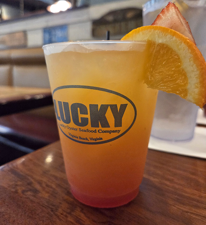 Their signature cocktail comes dressed for vacation with vibrant layers that match the coastal sunset you're too busy eating to watch.