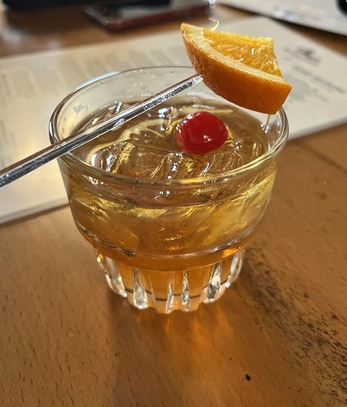 An old fashioned that Don Draper would approve of—amber liquid, proper garnish, and enough potency to make the tavern's ghost stories seem plausible.