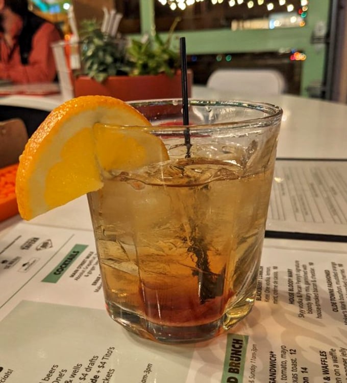 An old fashioned with a fresh orange slice – because sometimes the perfect chaser to smoky BBQ is a classic cocktail with a citrus wink.
