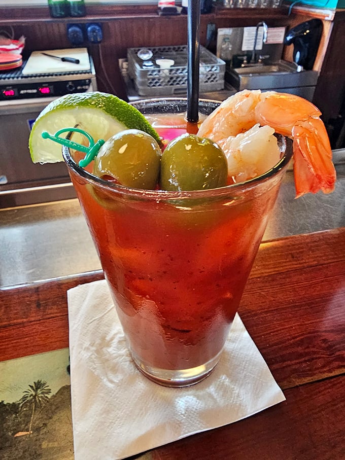 A Bloody Mary garnished with shrimp and olives—because drinking your vegetables is more fun when seafood is involved. Breakfast of champions, lunch of legends.