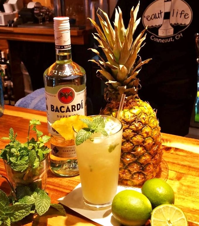 Cocktail artistry in full swing—where fresh mint, pineapple, and rum come together like old friends planning a beach vacation in your mouth.