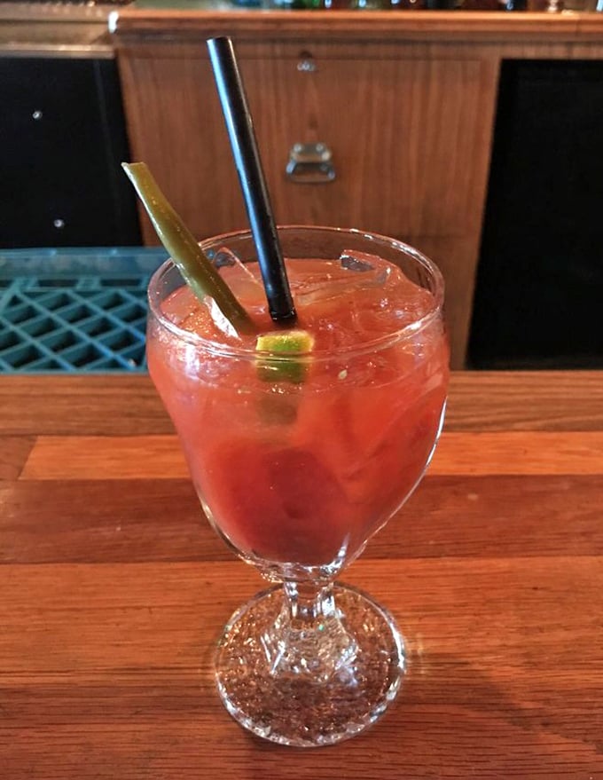 This vibrant cocktail isn't just a drink—it's a sunset in a glass, complete with a celery periscope for ocean viewing.