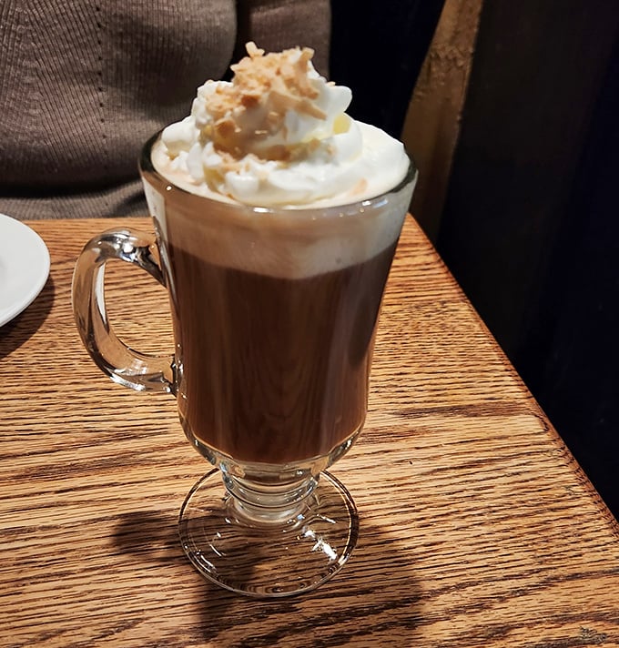 Their hot toddy isn't just a drink—it's a warm hug in a glass, topped with whipped cream that melts into the richness below.