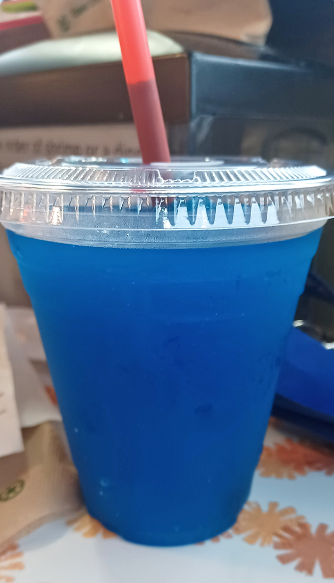 That electric blue drink isn't trying to be sophisticated—it's promising pure, unadulterated fun, like a swimming pool you can sip through a straw.