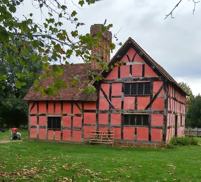 Not your typical fixer-upper. This vibrant red timber-framed English farmhouse represents the architectural traditions many settlers brought to America.