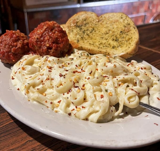Fettuccine Alfredo that doesn't whisper "comfort food" – it belts it out like Pavarotti, with red pepper flakes providing the perfect high note to the creamy symphony. 