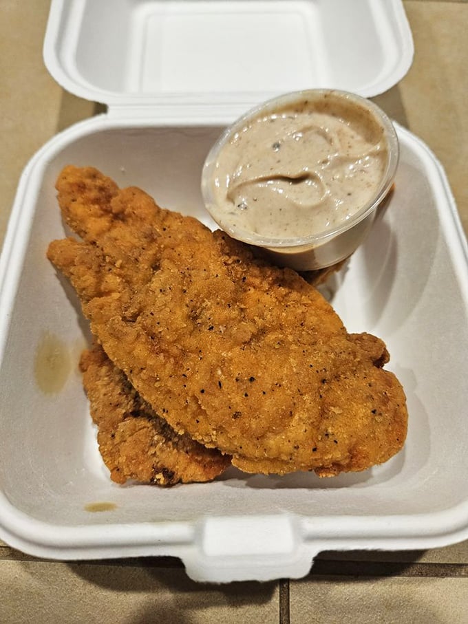 Golden-fried fish fillets with a side of creamy sauce—proof that sometimes the simplest pleasures are the most satisfying.