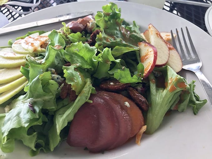 A salad that doesn't feel like punishment. Fresh greens, seasonal fruit, and what appears to be perfectly seared protein—healthy eating never looked so tempting.