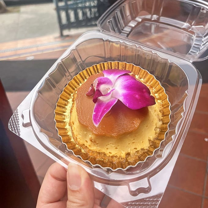 This flan, adorned with an orchid, isn't just dessert—it's a silky, caramel-kissed performance that deserves its own standing ovation.
