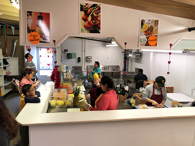 This isn't just a food stall—it's a portal to another country. Those fruit cups are edible passports to somewhere sunnier and more delicious.