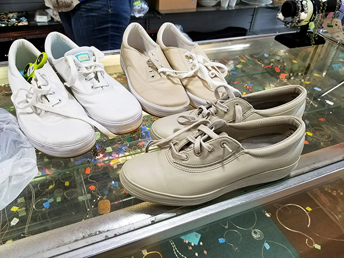 White sneakers lined up like hopeful contestants at a talent show—barely worn and ready for their second act.