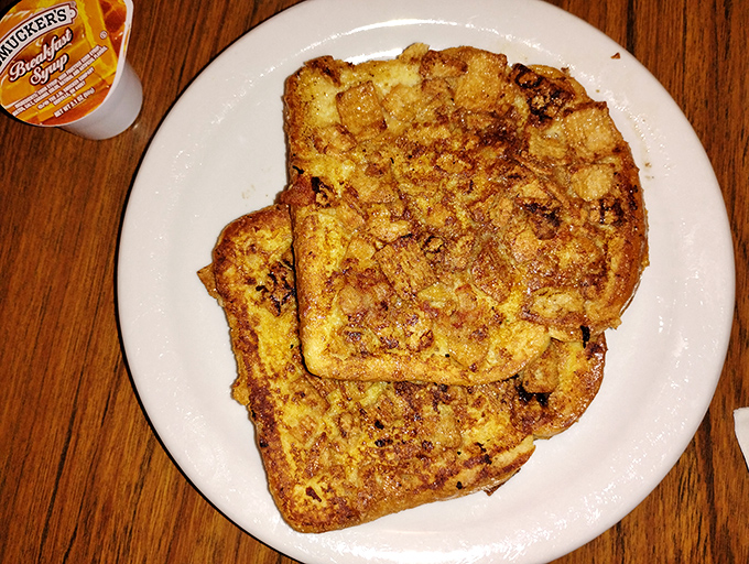 French toast that's achieved the impossible balance – crispy edges giving way to a custardy center that makes you question all other breakfast choices.