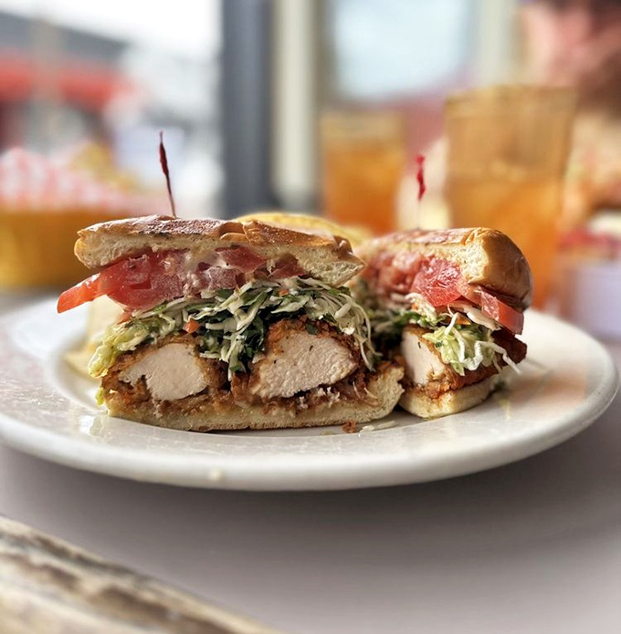 This fried chicken sandwich towers with crispy perfection that would make any grandmother beam with pride.