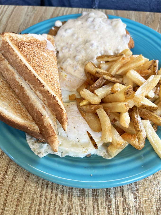 Country fried steak smothered in gravy with eggs on top—because sometimes breakfast should be wearing a cowboy hat and boots. 
