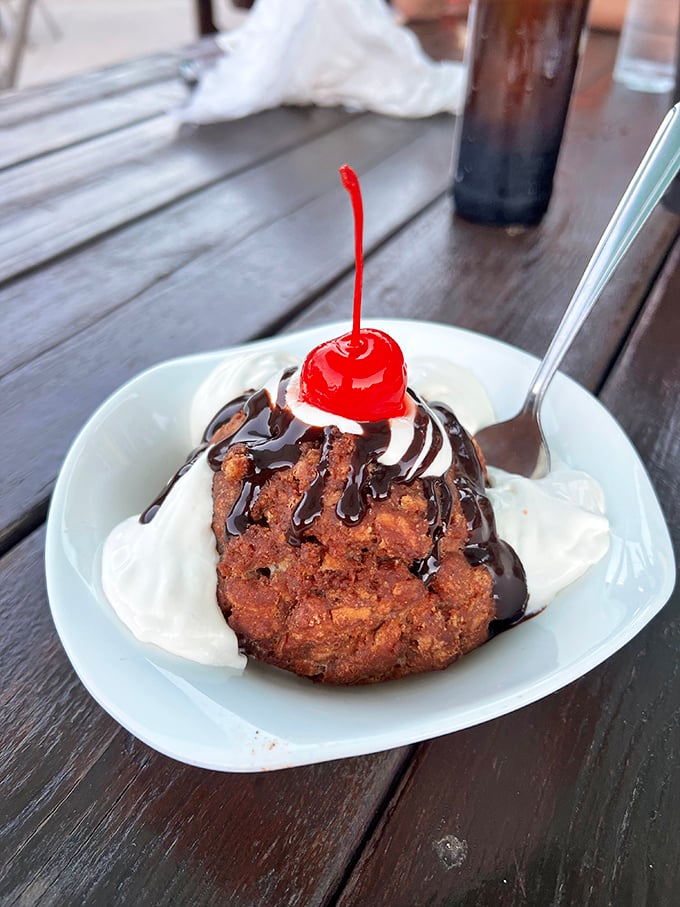 Deep-fried ice cream with chocolate drizzle and a cherry on top—dessert that perfectly balances "I shouldn't" with "I absolutely must."