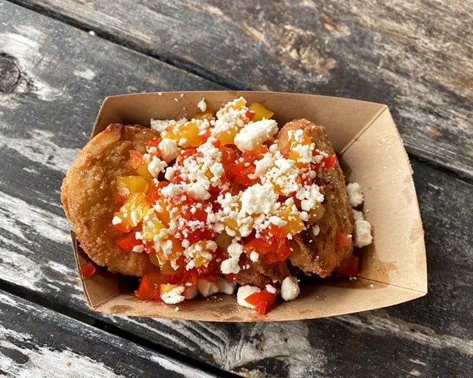 These aren't just fried green tomatoes—they're little Southern discs of joy, topped with a colorful medley of peppers and crumbled cheese.