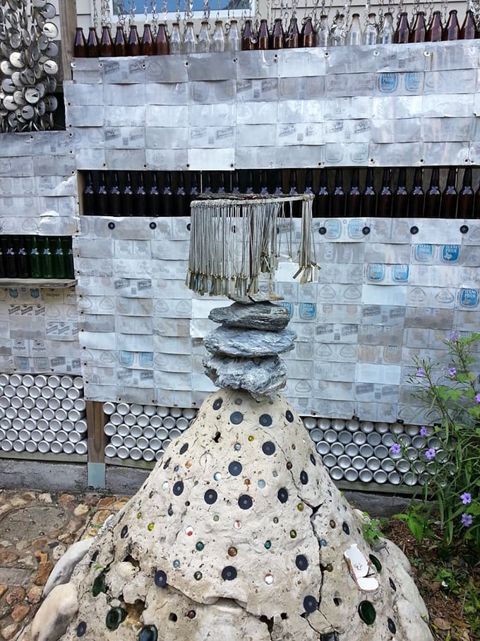 Beyond the house, the garden pathways incorporate bottle caps and marbles, creating a mosaic effect that would make Gaudí raise his glass.