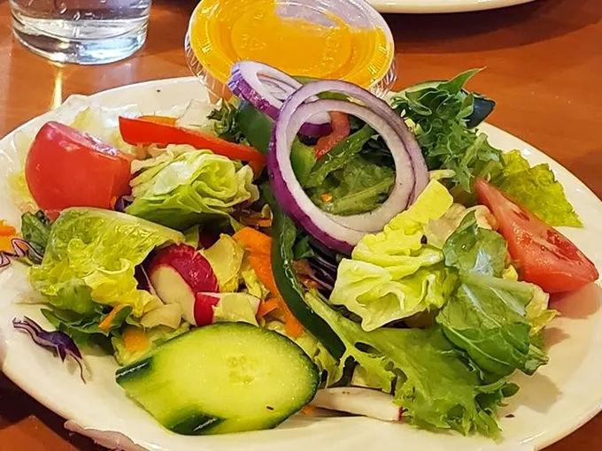 A garden salad that actually looks like a garden—crisp, colorful, and the perfect counterbalance to that stack of pancakes you just demolished.