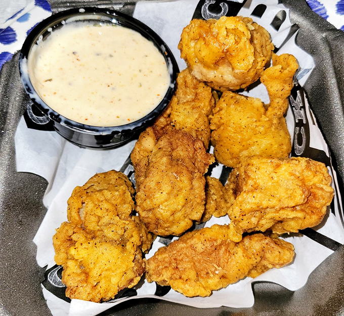 Crispy golden nuggets nestled among fries and pulled meat—proof that sometimes the best things in life come in unexpected packages.