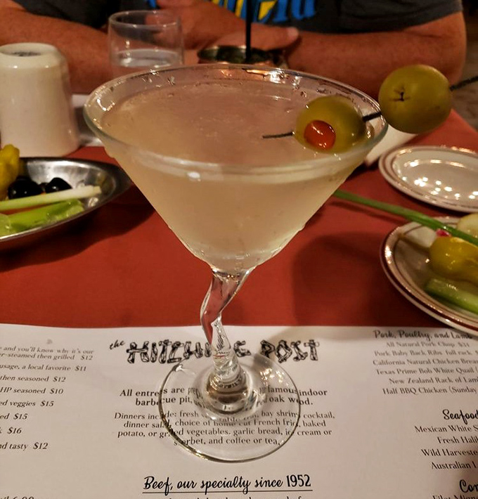The martini arrives crystal clear and ice-cold—a civilized prelude to the primal pleasure of oak-fired meat.